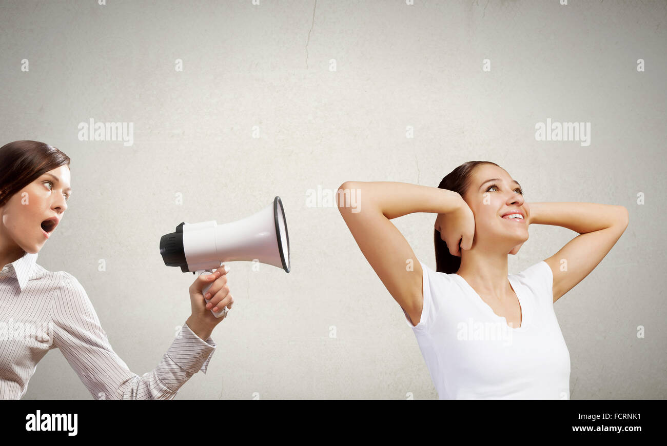 Young furious woman screaming agressively in megaphone Stock Photo - Alamy