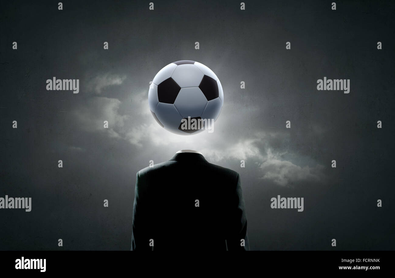 Unrecognizable man with soccer ball instead of head Stock Photo - Alamy