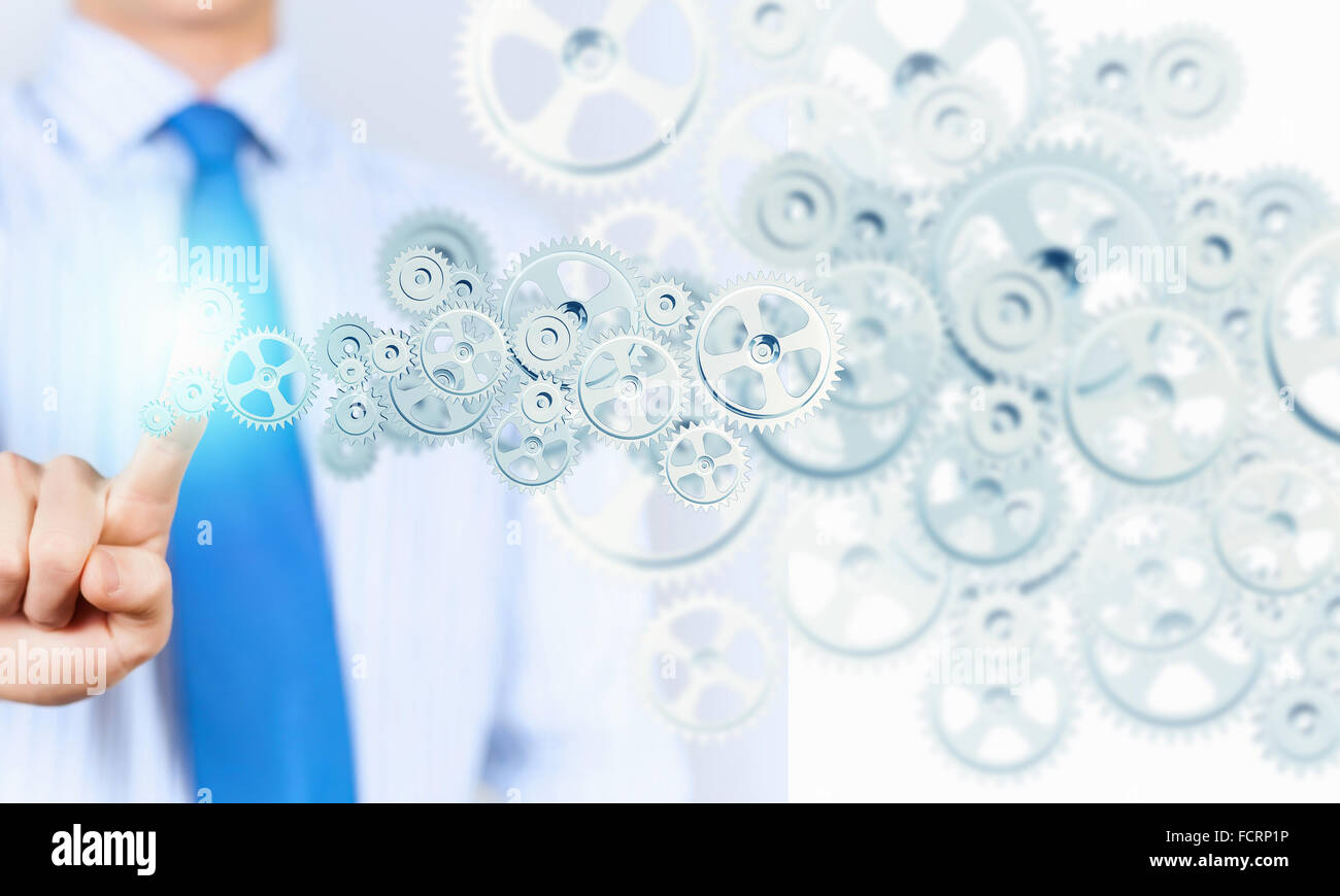 Close up of businessman touching gears mechanism with finger Stock ...