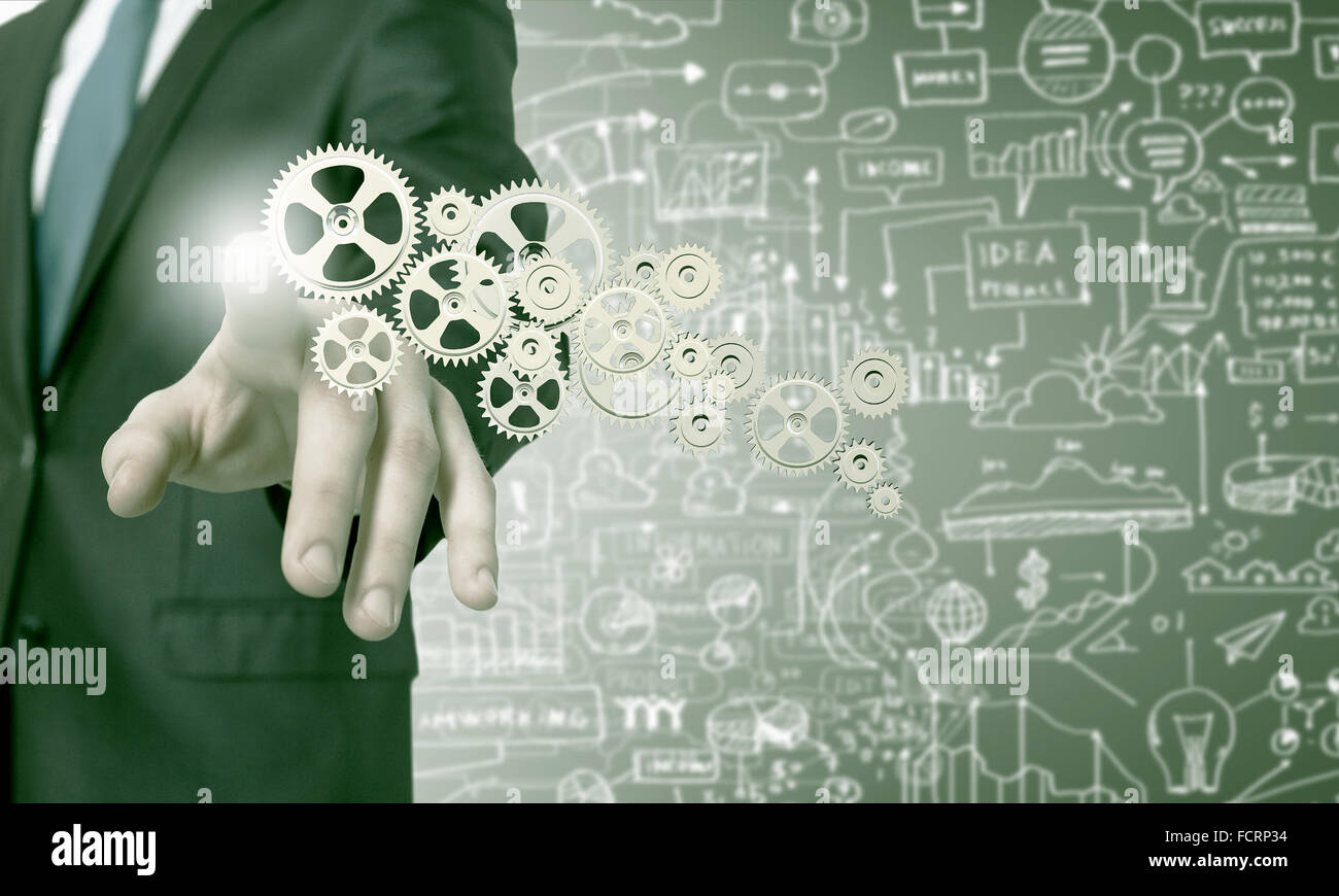 Close up of businessman touching gears mechanism with finger Stock ...