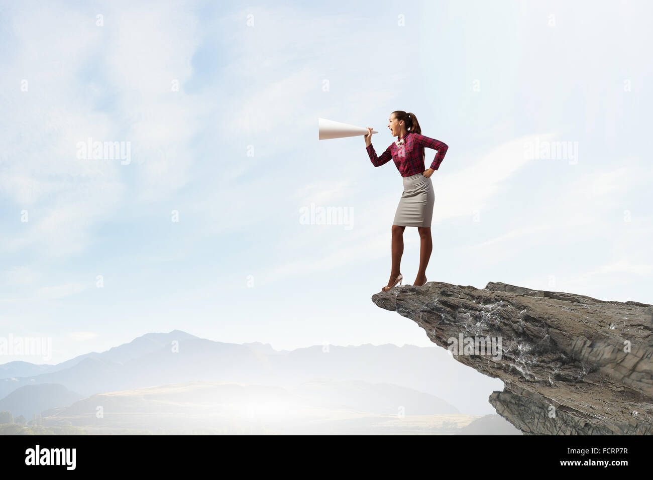 Young woman making some announcement in trumpet Stock Photo - Alamy
