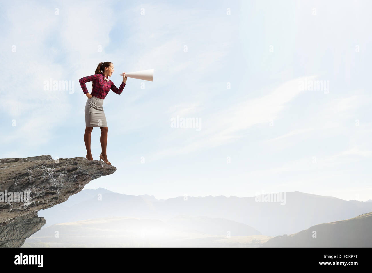 Young woman making some announcement in trumpet Stock Photo - Alamy