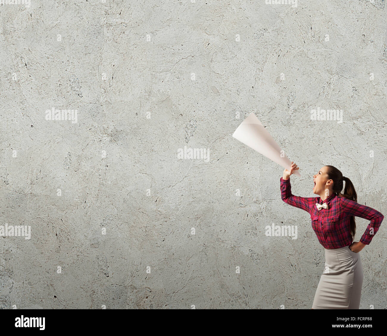 Young woman making some announcement in trumpet Stock Photo - Alamy