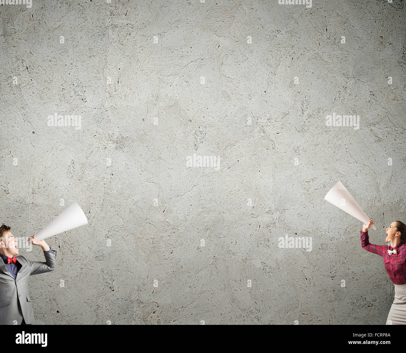Young people screaming at each other in trumpet Stock Photo - Alamy