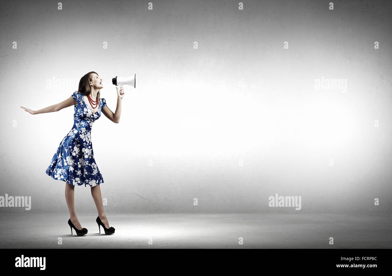 Young woman making some announcement in trumpet Stock Photo - Alamy