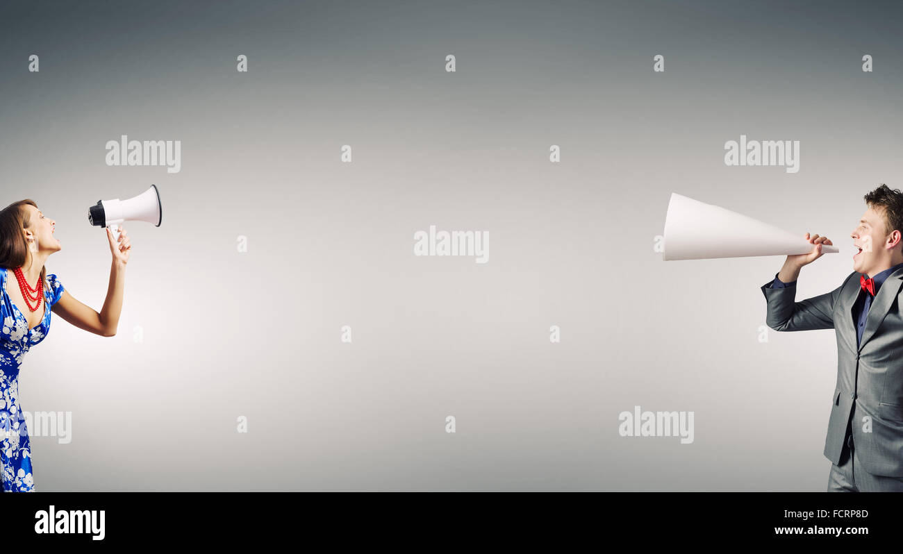 Young people screaming at each other in trumpet Stock Photo - Alamy