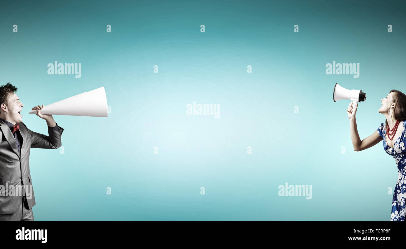 Young people screaming at each other in trumpet Stock Photo - Alamy