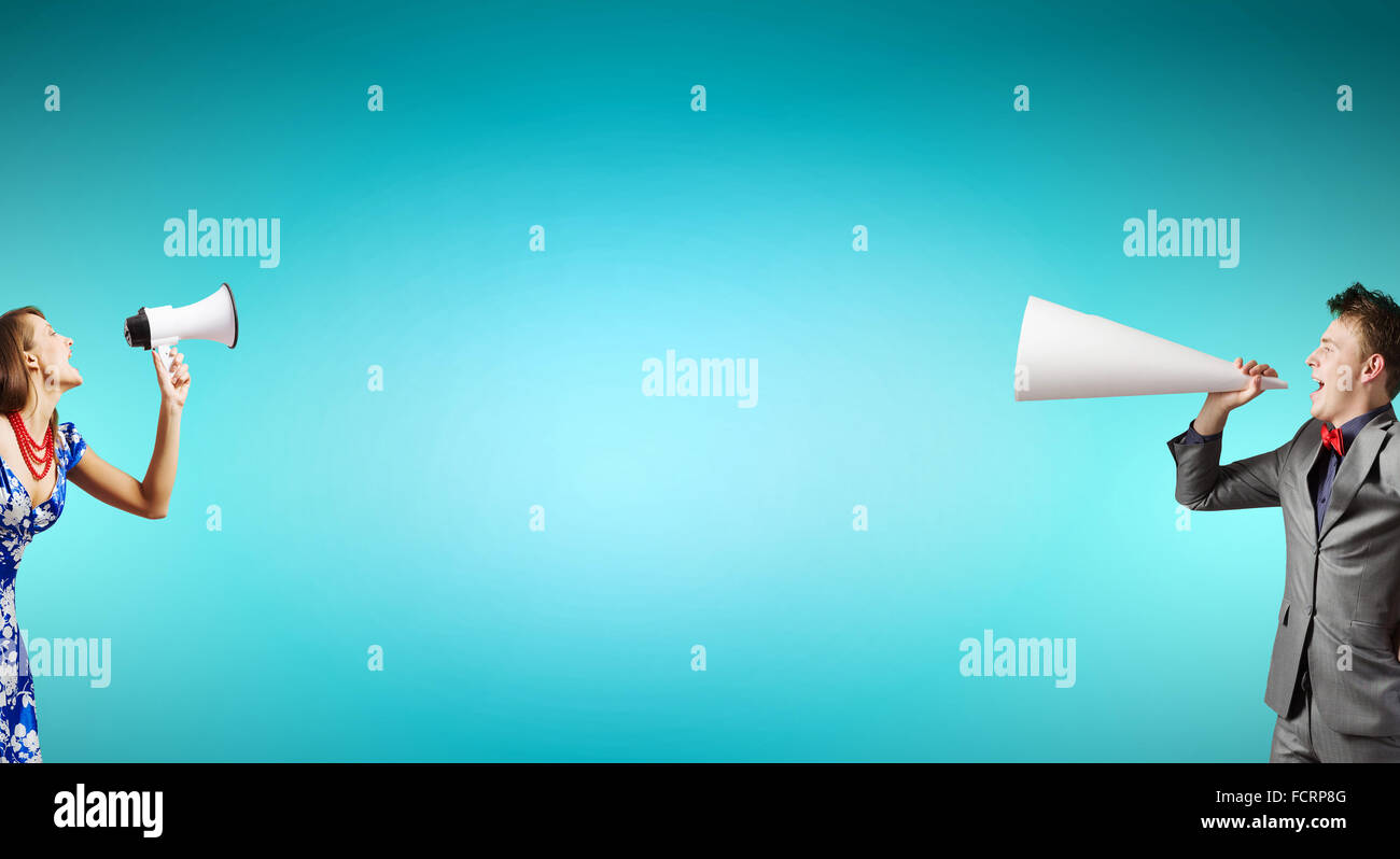 Young people screaming at each other in trumpet Stock Photo - Alamy