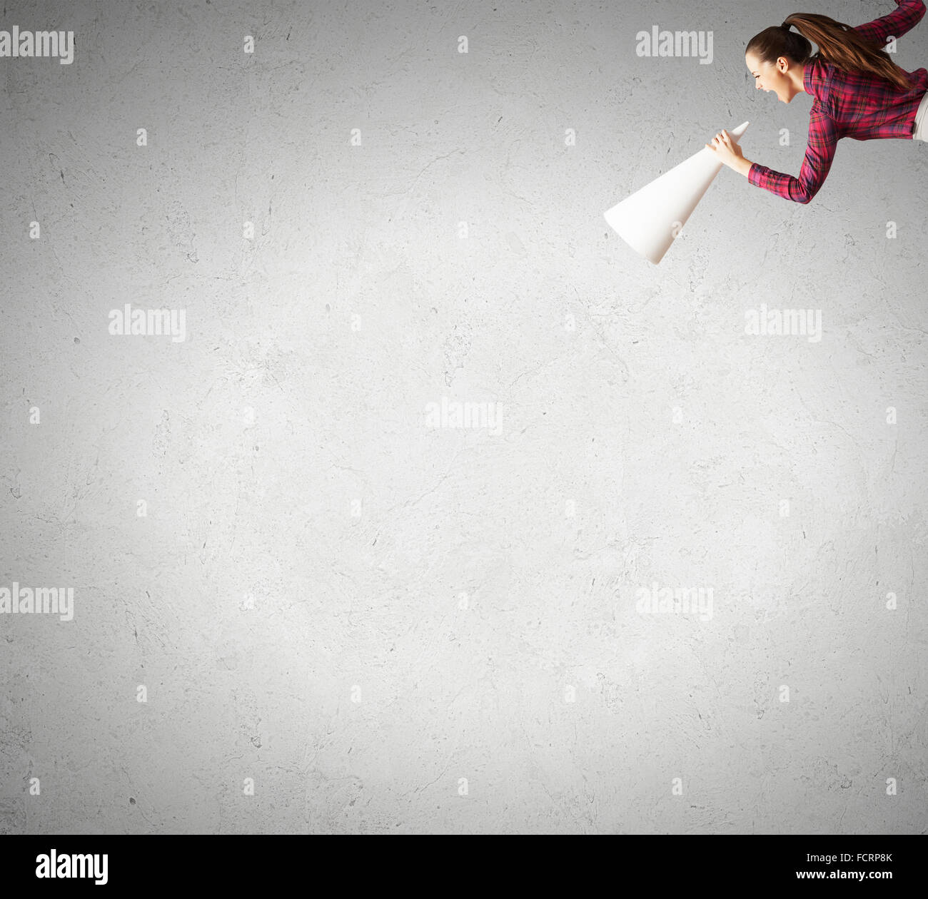 Young woman making some announcement in trumpet Stock Photo - Alamy