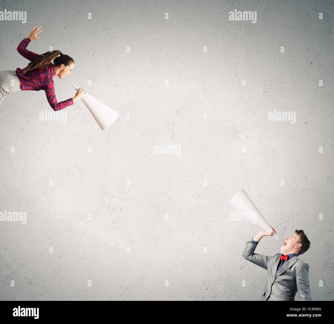 Young people screaming at each other in trumpet Stock Photo - Alamy