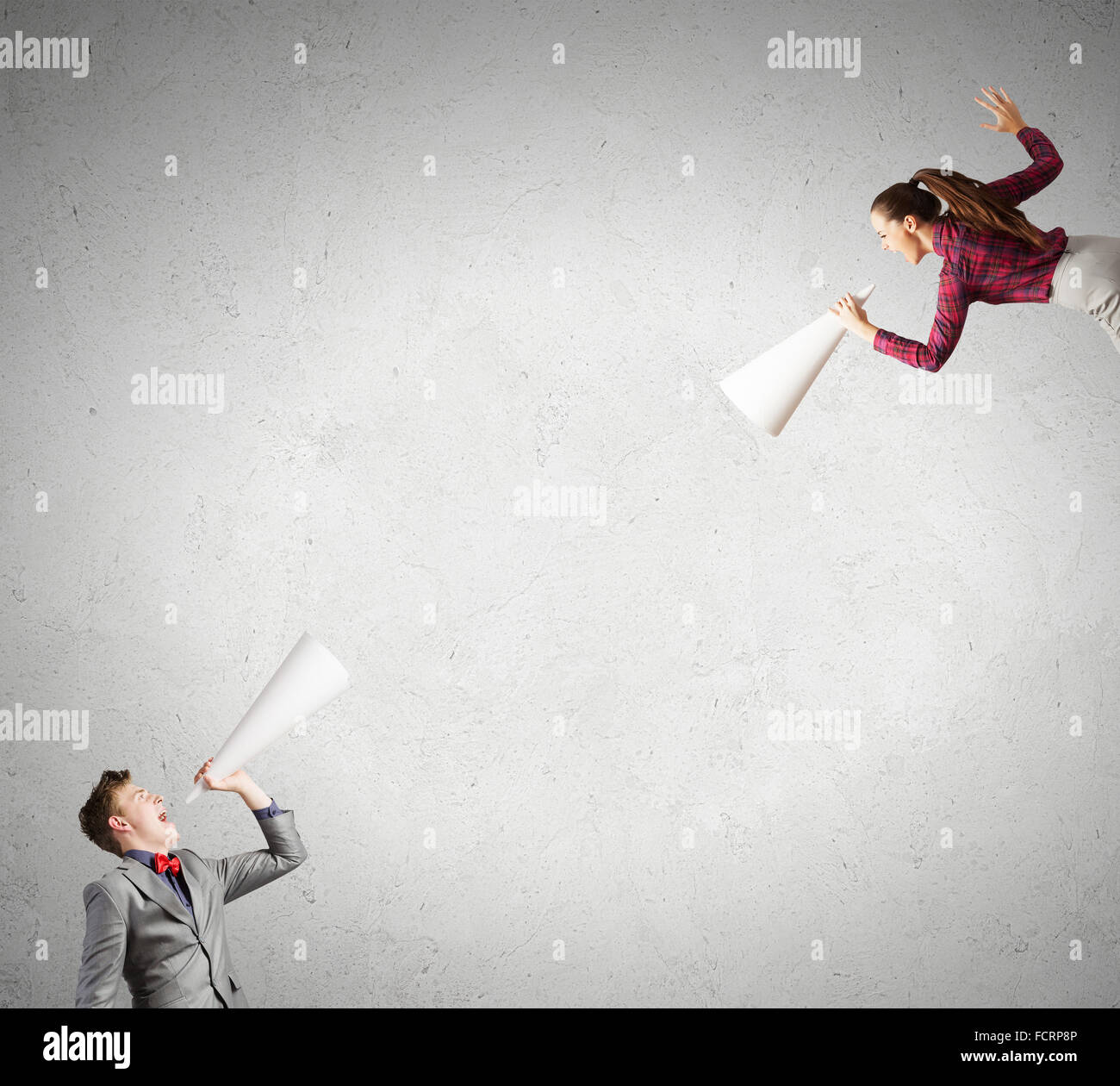 Young people screaming at each other in trumpet Stock Photo - Alamy