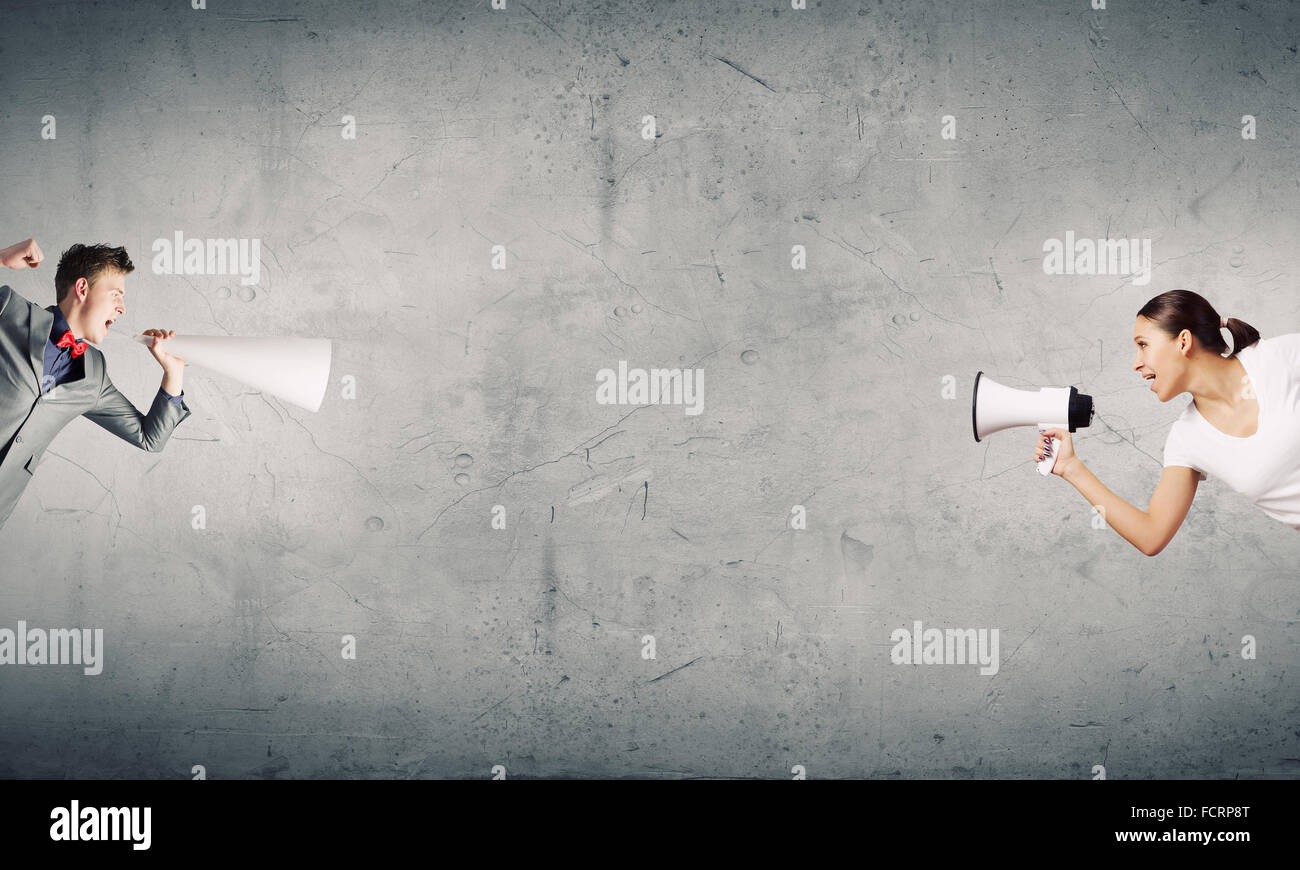Young people screaming at each other in trumpet Stock Photo - Alamy