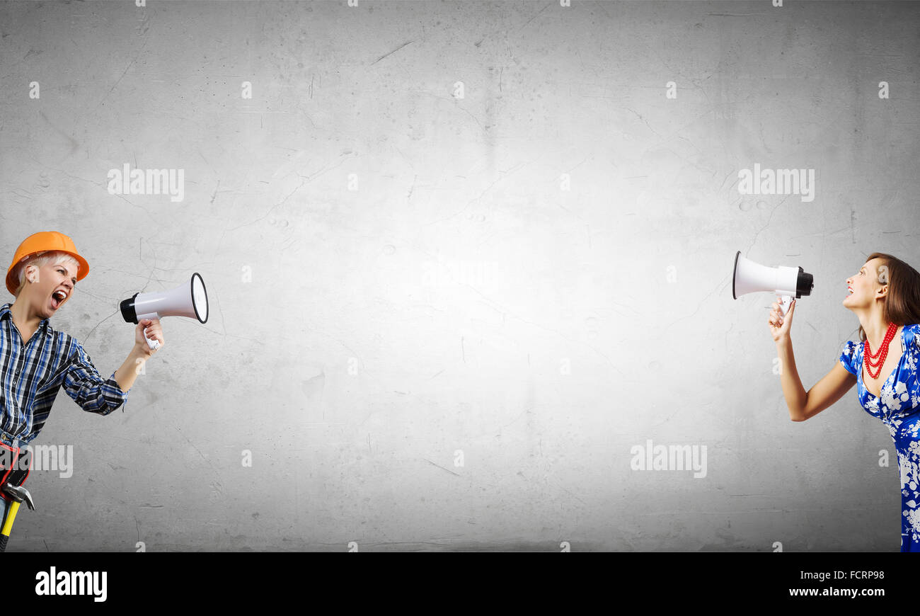 Young people screaming at each other in trumpet Stock Photo - Alamy