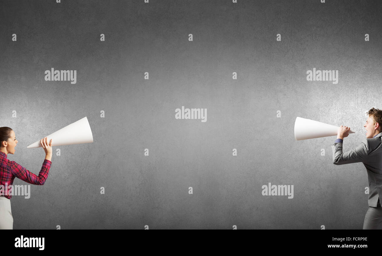 Young people screaming at each other in trumpet Stock Photo - Alamy