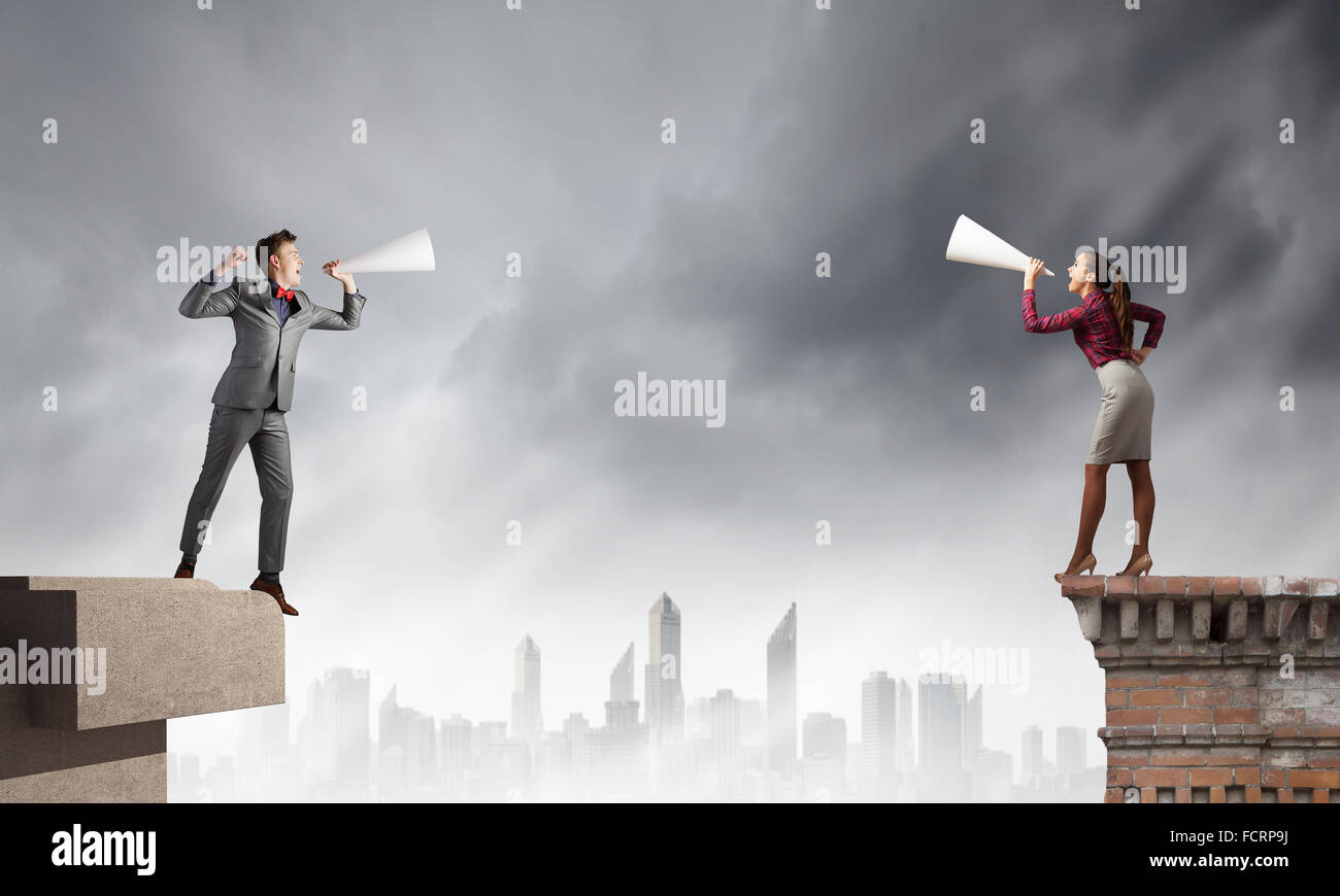 Young people screaming at each other in paper trumpet Stock Photo - Alamy