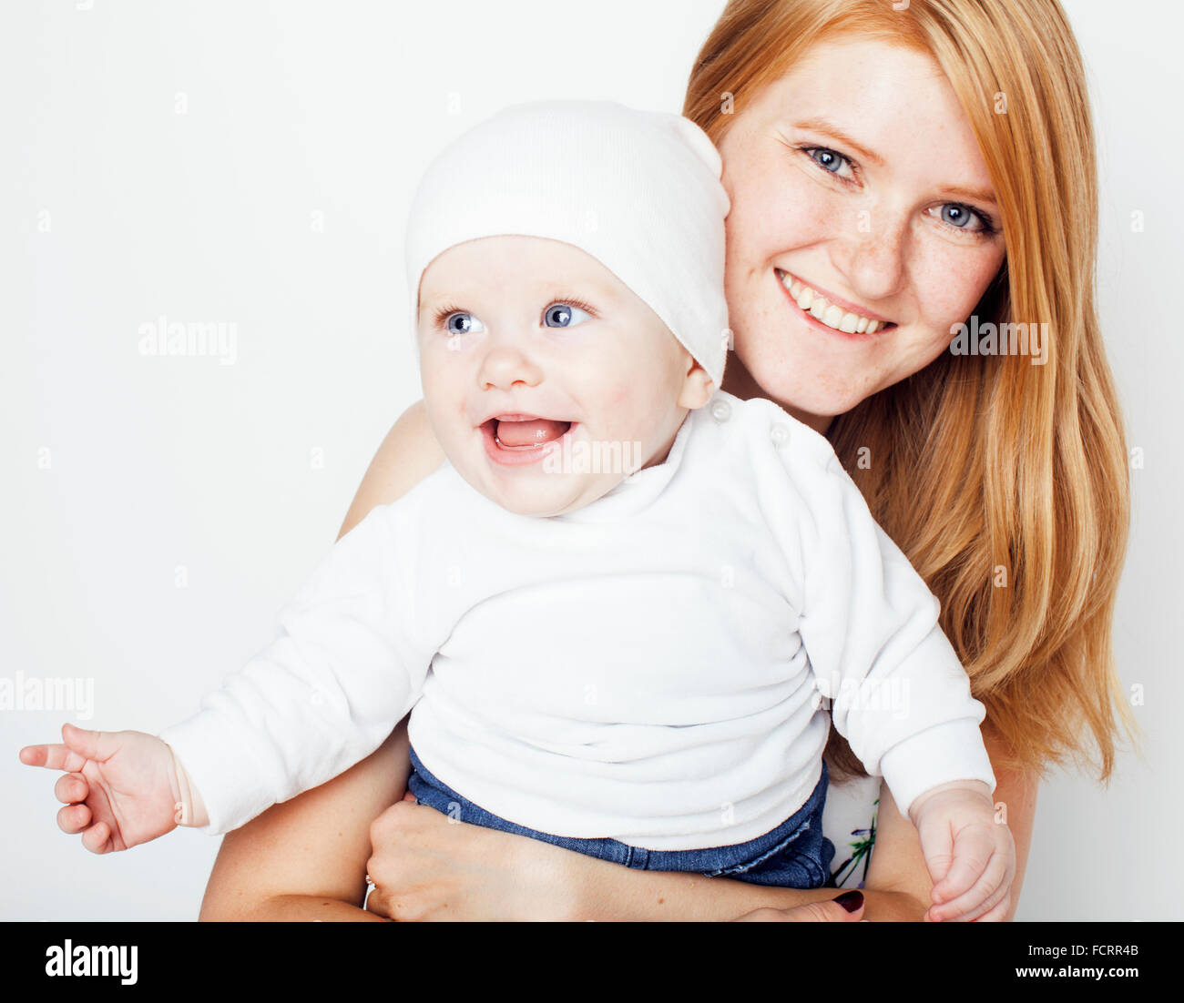 young beauty mother with baby, red head happy family isolated Stock ...