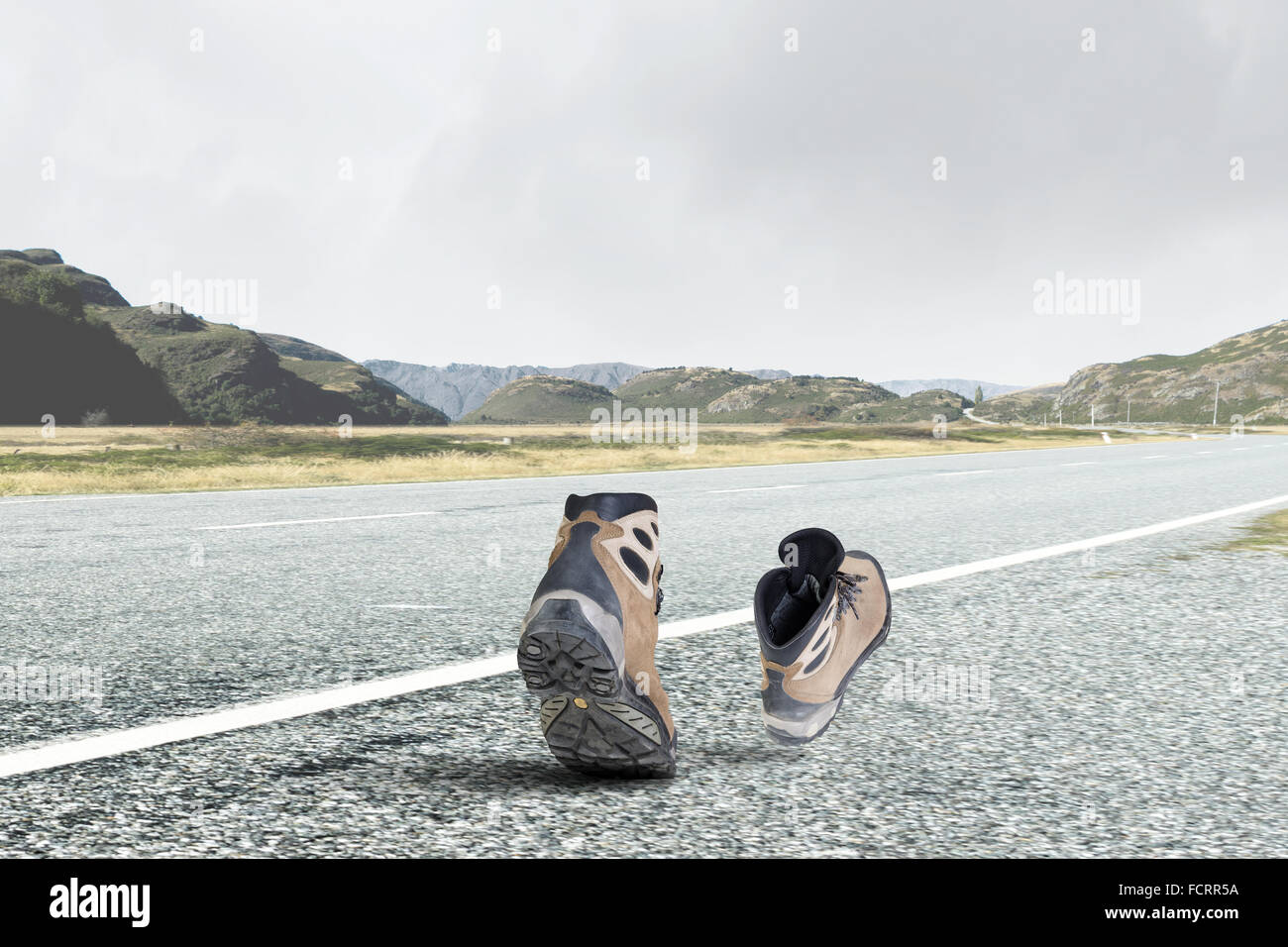 Pair of hikers boots walking on path Stock Photo - Alamy