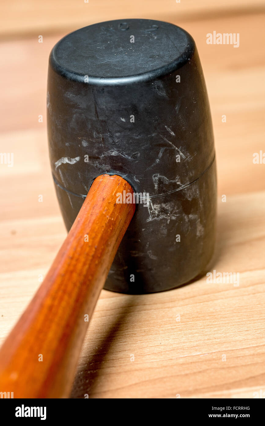 Well used black rubber mallet with wood handle Stock Photo - Alamy