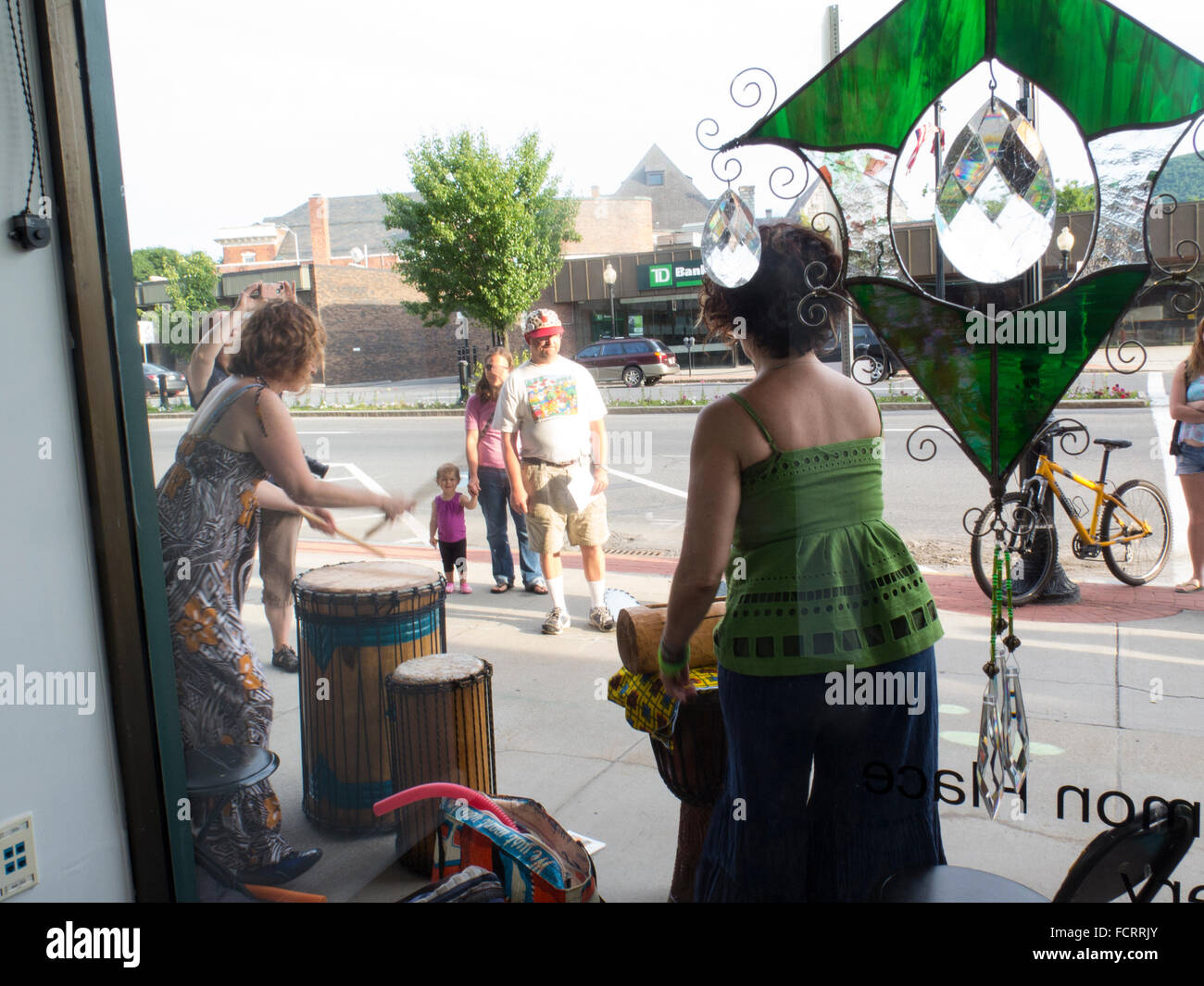 People gather outside an art exhibit to hear music at a public art ...