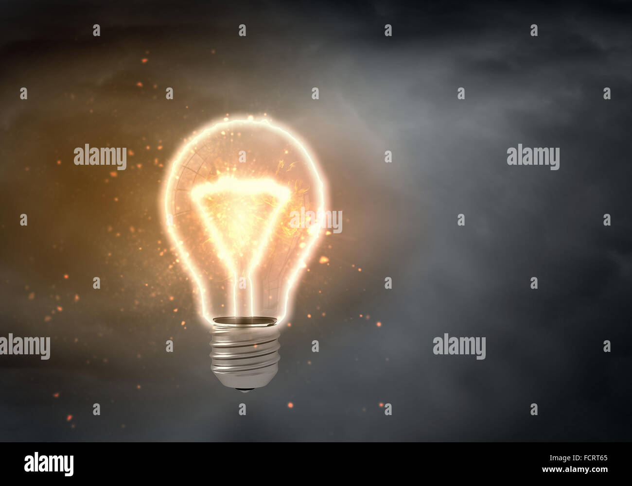 Light bulb turned on over black background Stock Photo - Alamy