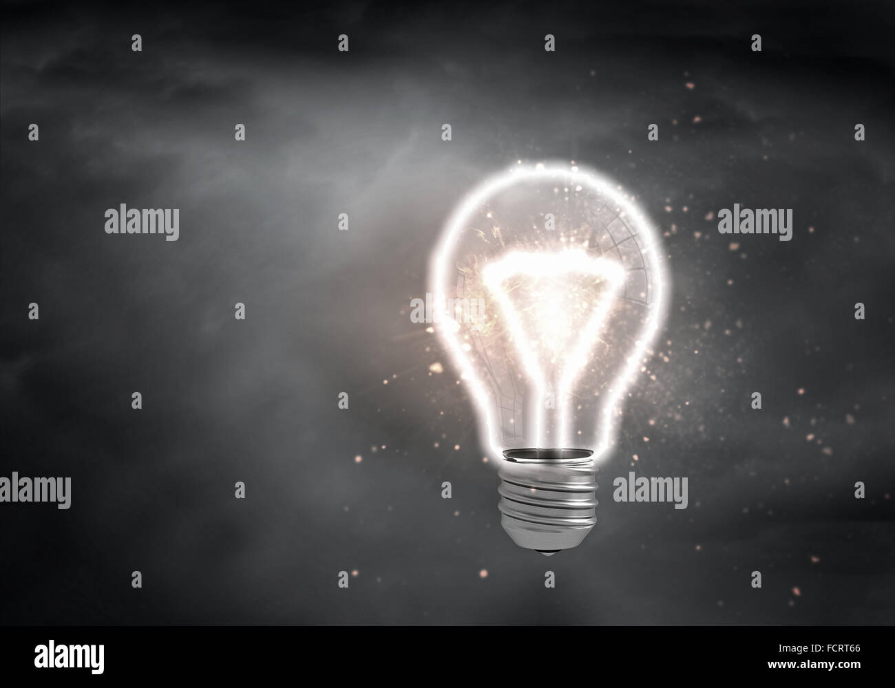 Light bulb turned on over black background Stock Photo - Alamy