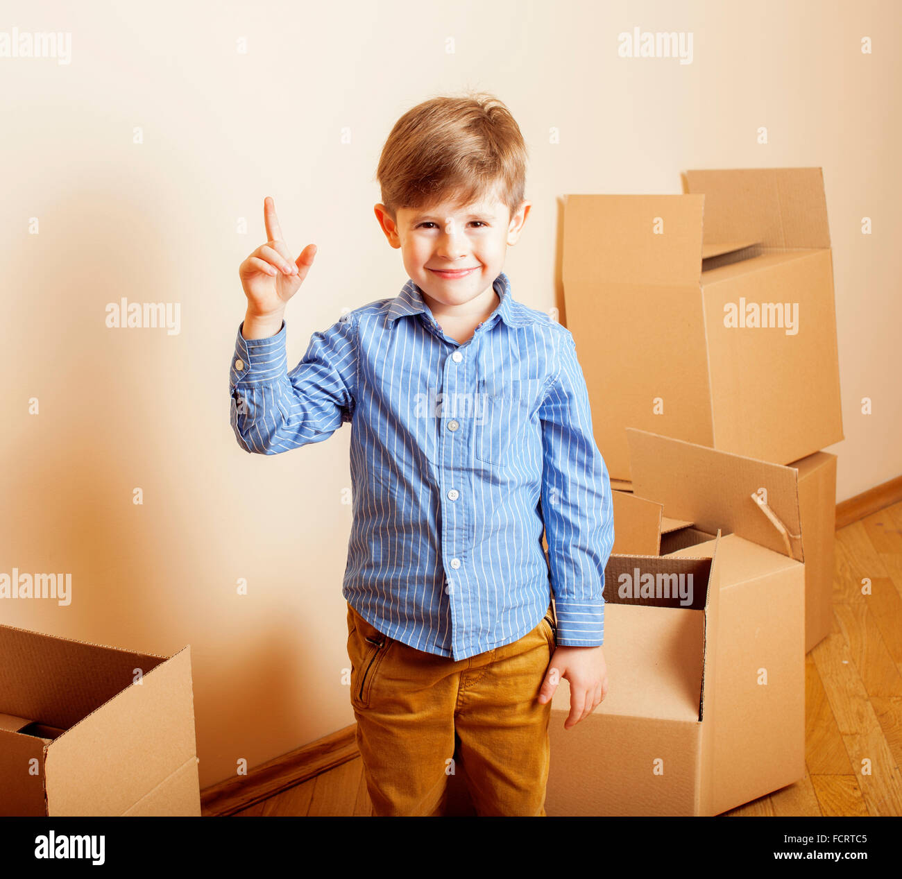 little cute boy in empty room, remoove to new house. home alone emong ...