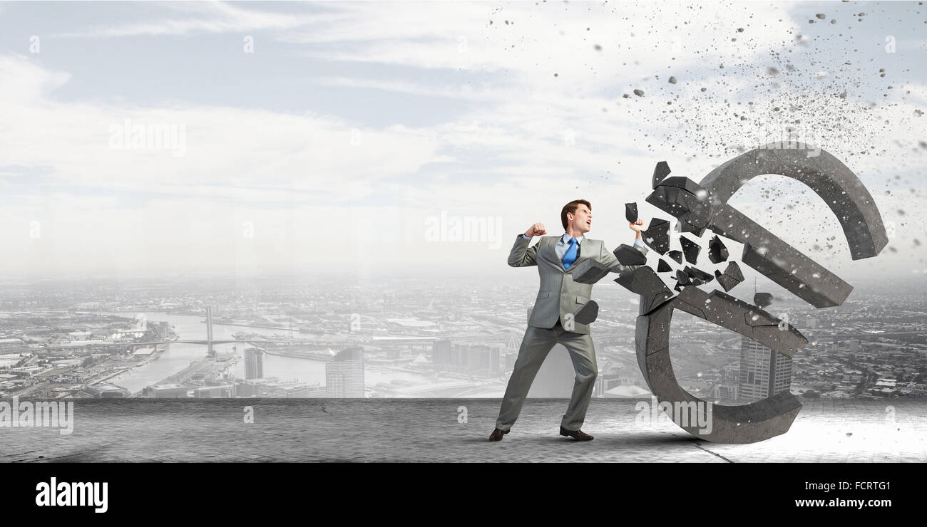 Businessman breaking stone euro symbol with karate punch Stock Photo ...