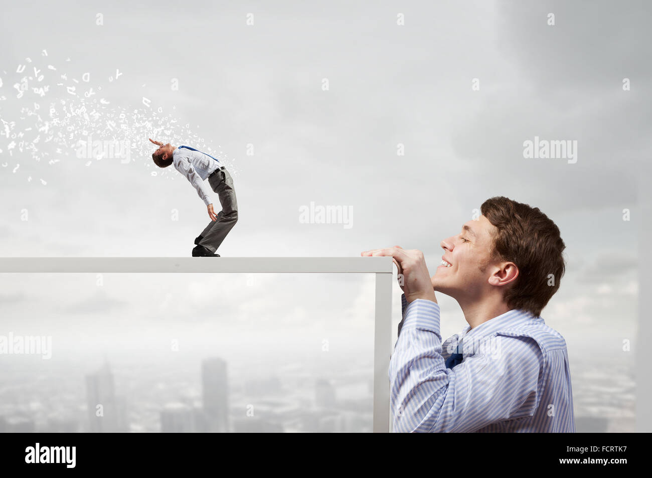 Funny young man looking from under table Stock Photo - Alamy
