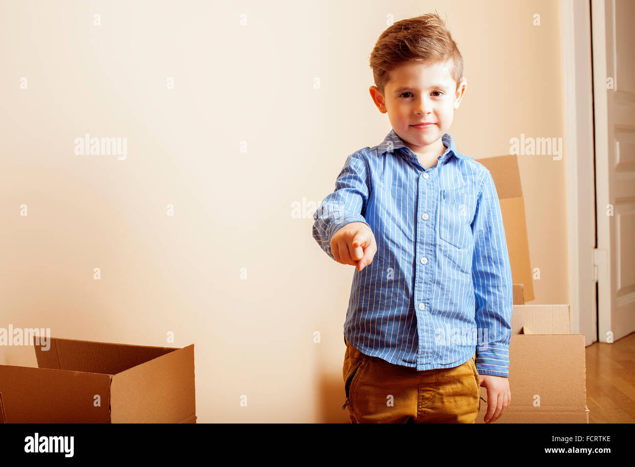little cute boy in empty room, remoove to new house. home alone emong ...