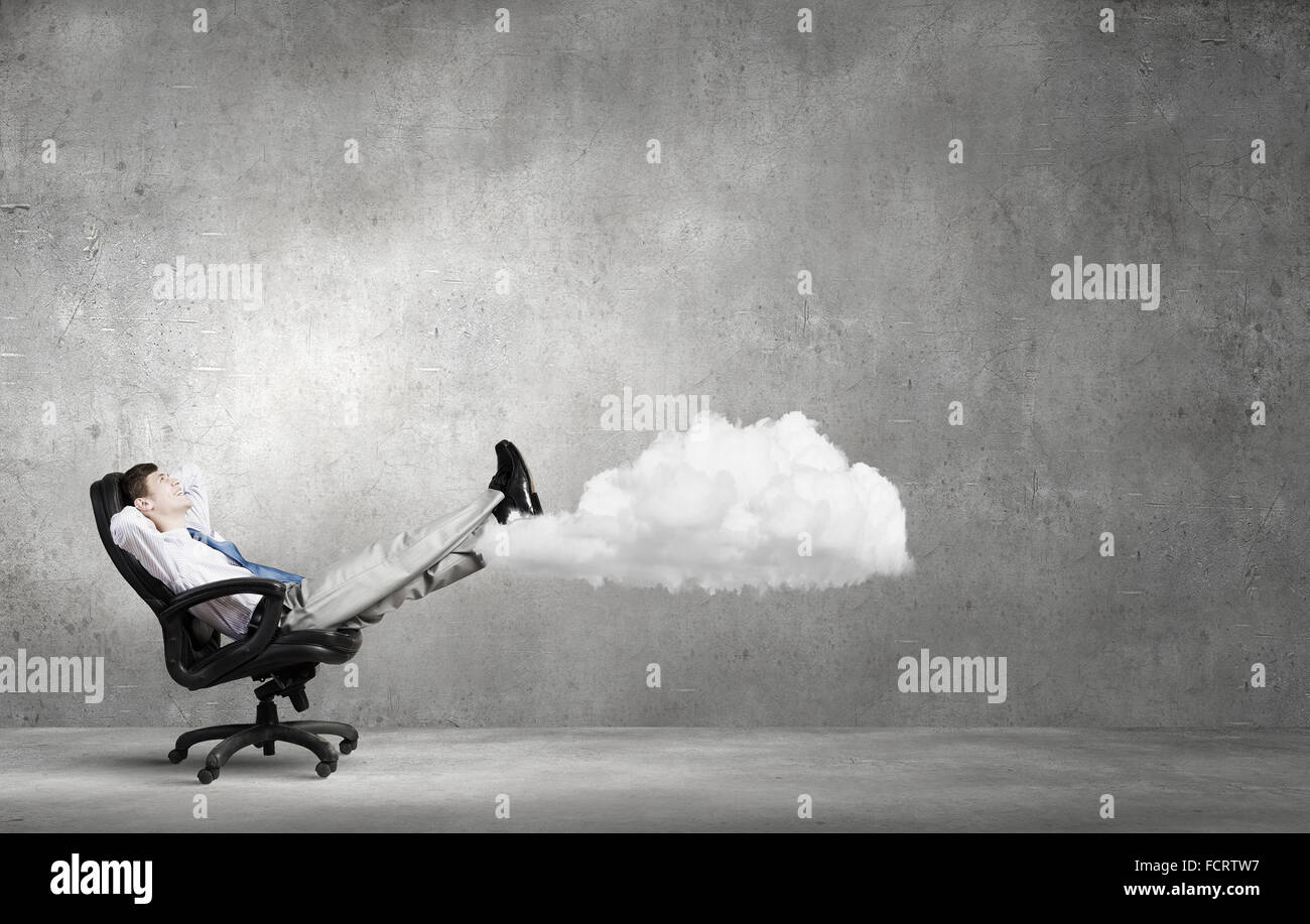 Confident businessman sitting on chair with legs up Stock Photo - Alamy