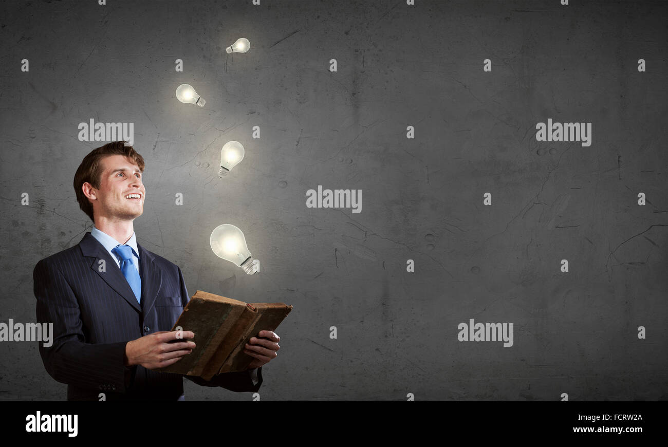 Young handsome man in suit reading old book Stock Photo - Alamy