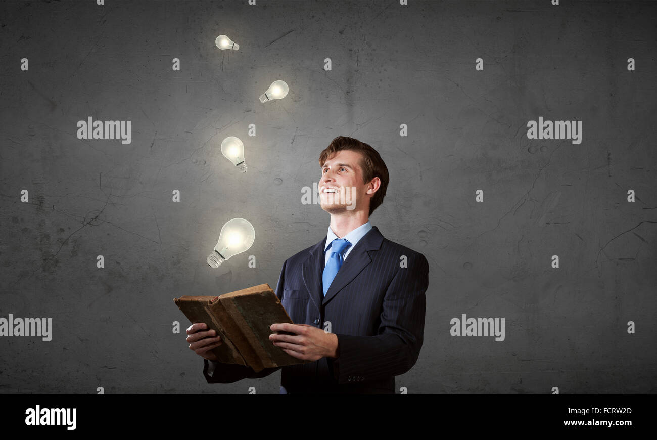 Young handsome man in suit reading old book Stock Photo - Alamy