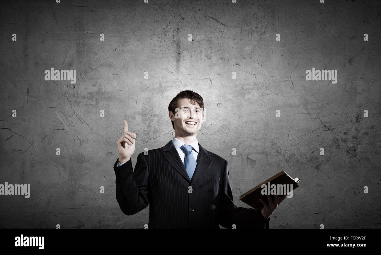 Young handsome man in suit reading old book Stock Photo - Alamy