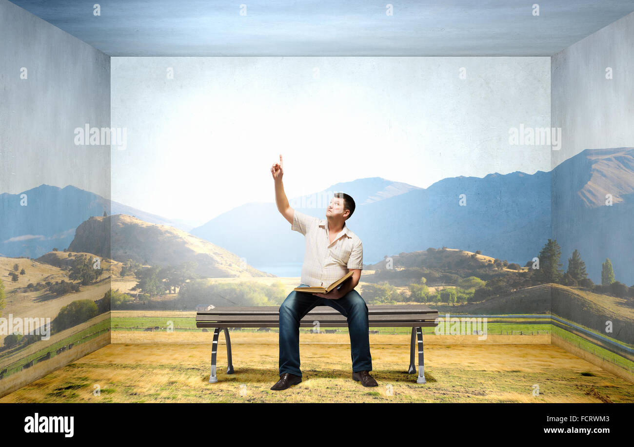 Fat man sitting on bench with book and reaching hand Stock Photo - Alamy