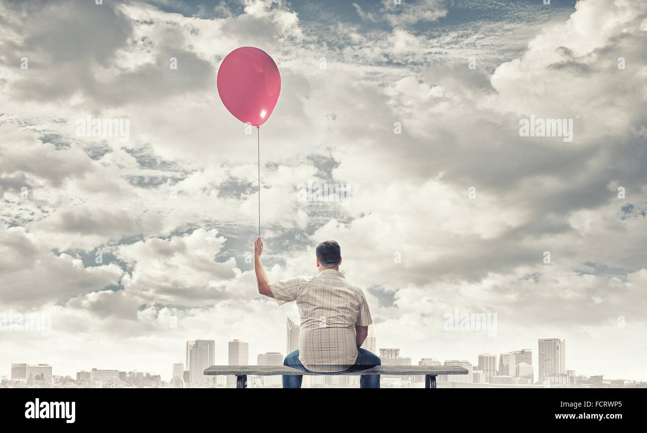 Fat man sitting on bench with his back and looking away Stock Photo - Alamy