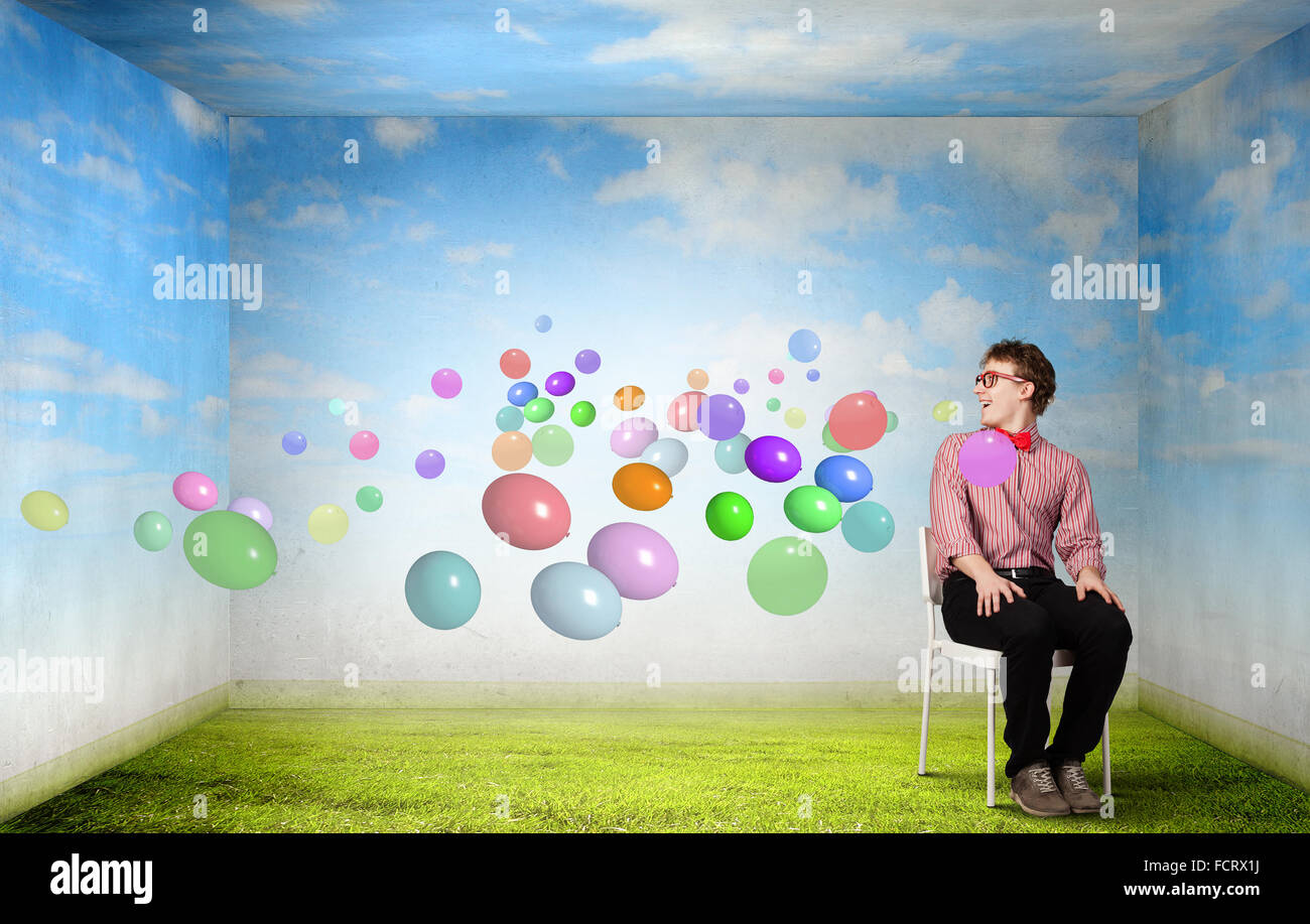 Young funny teenager guy sitting in chair Stock Photo - Alamy