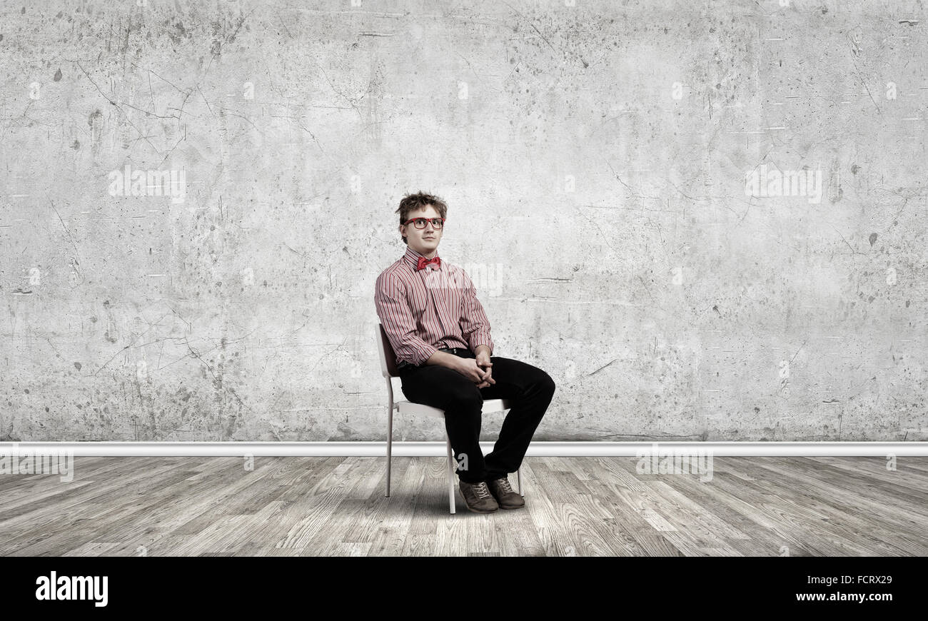 Young funny teenager guy sitting in chair Stock Photo - Alamy
