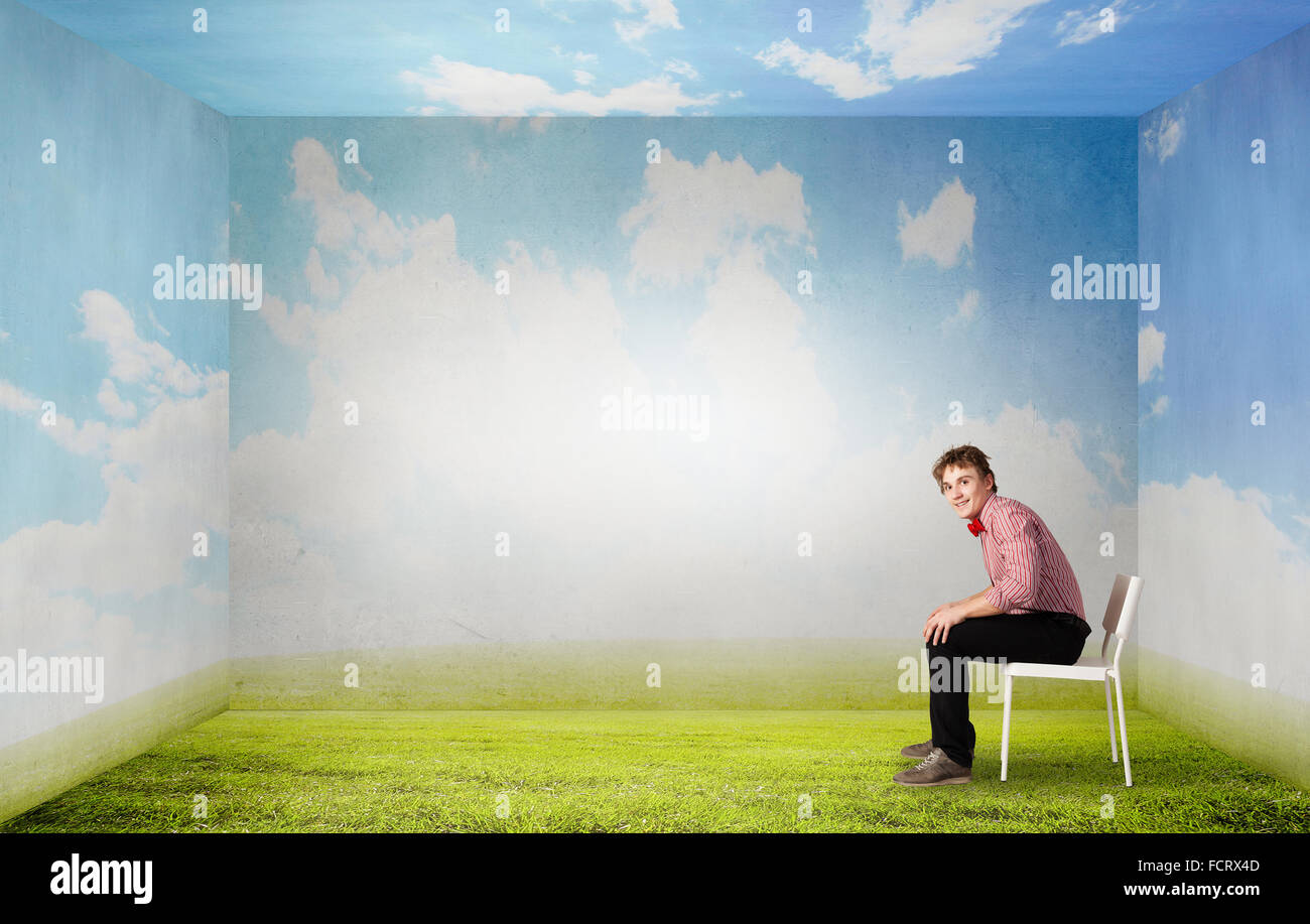 Young funny teenager guy sitting in chair Stock Photo - Alamy