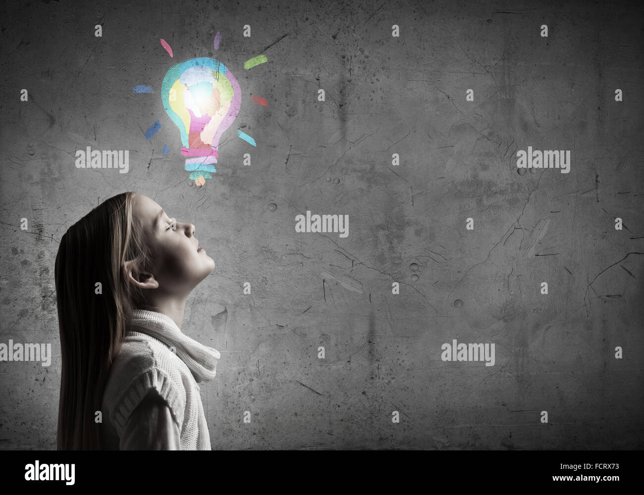 Side view of girl of school age looking at brain above Stock Photo - Alamy