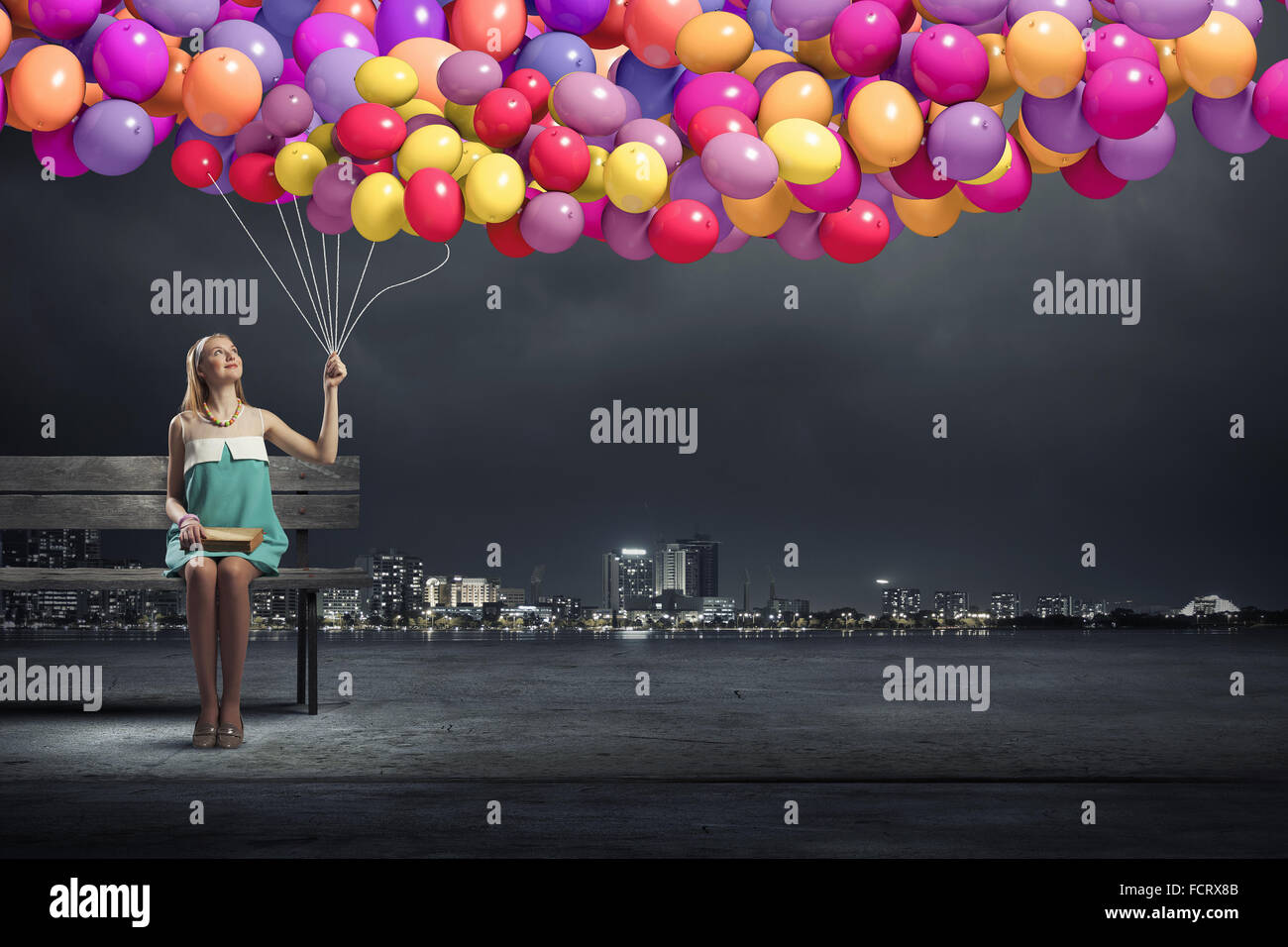 Young beautiful lady sitting on bench and reading book Stock Photo - Alamy