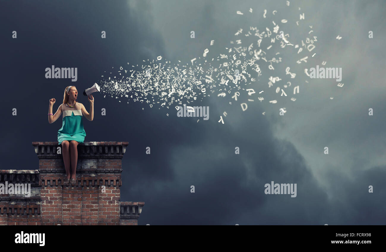 Young woman sitting on roof and screaming in megaphone Stock Photo - Alamy
