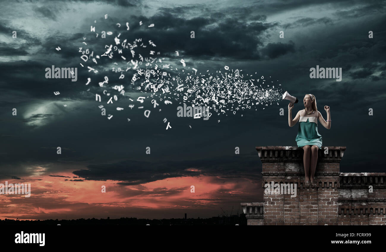 Young woman sitting on roof and screaming in megaphone Stock Photo - Alamy