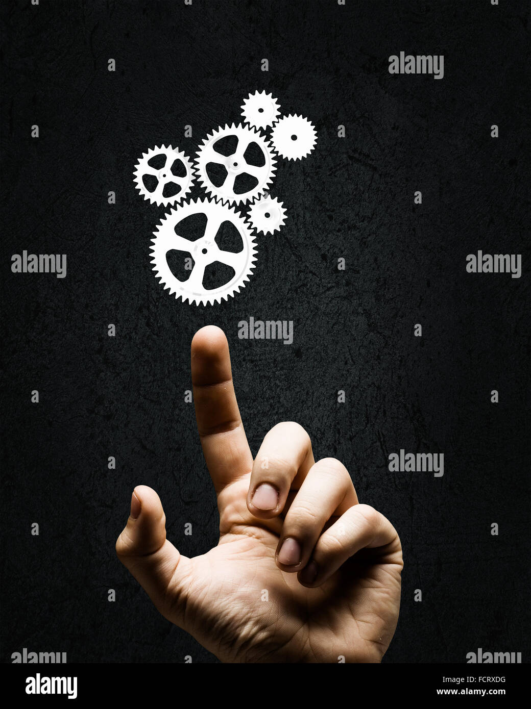 Close up human hand pointing at gears mechanism Stock Photo - Alamy