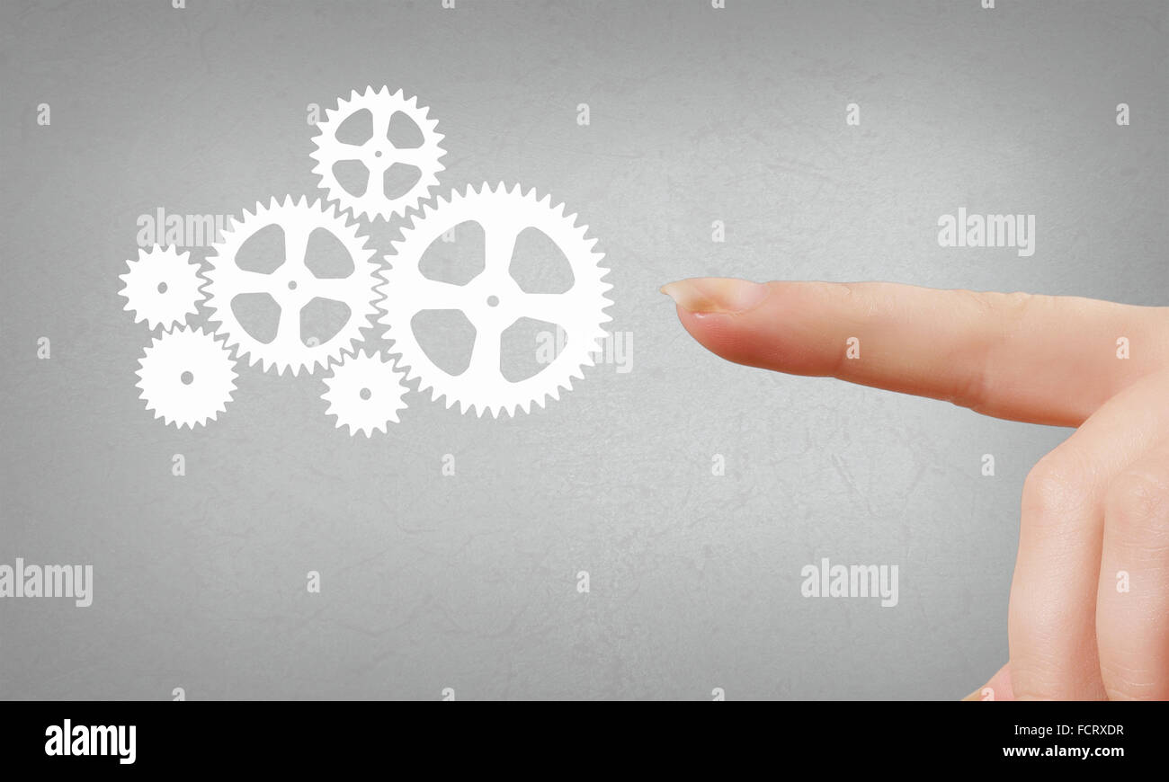 Close up human hand pointing at gears mechanism Stock Photo - Alamy