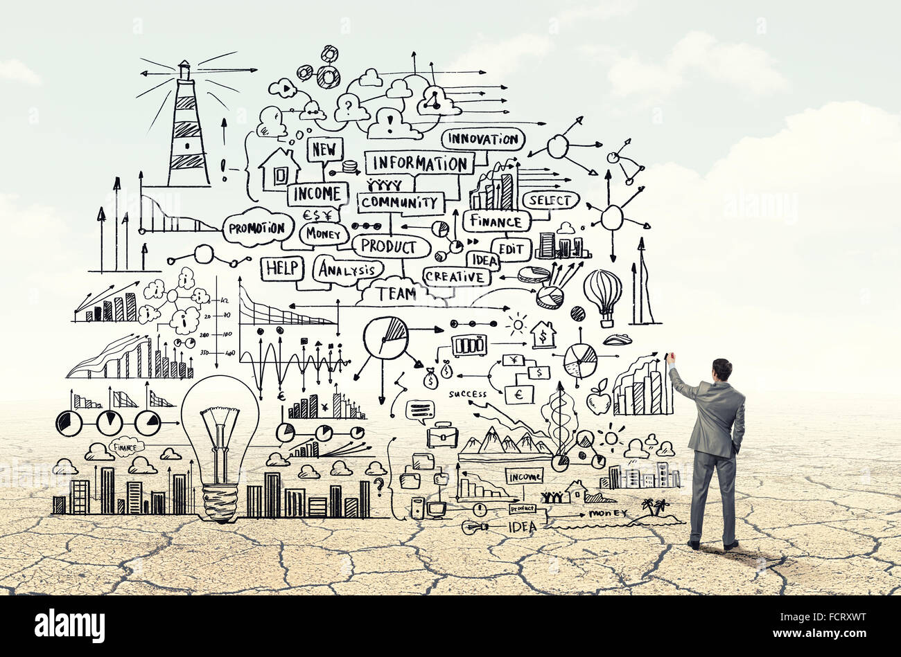 Back view of businessman drawing business sketches on wall Stock Photo ...