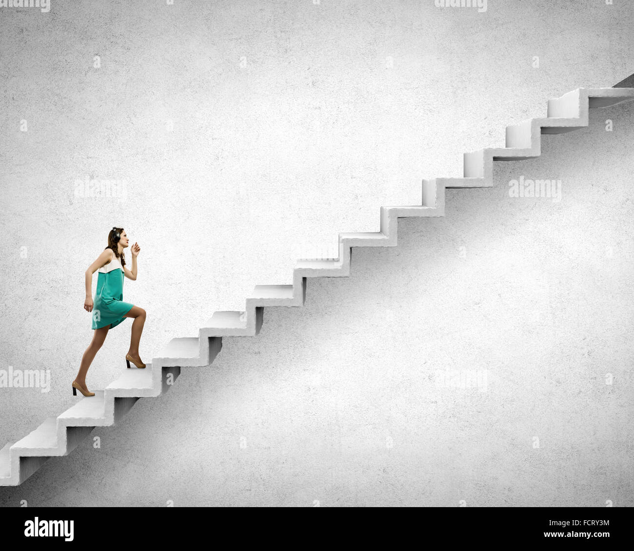 Young businesswoman walking up on staircase representing success ...