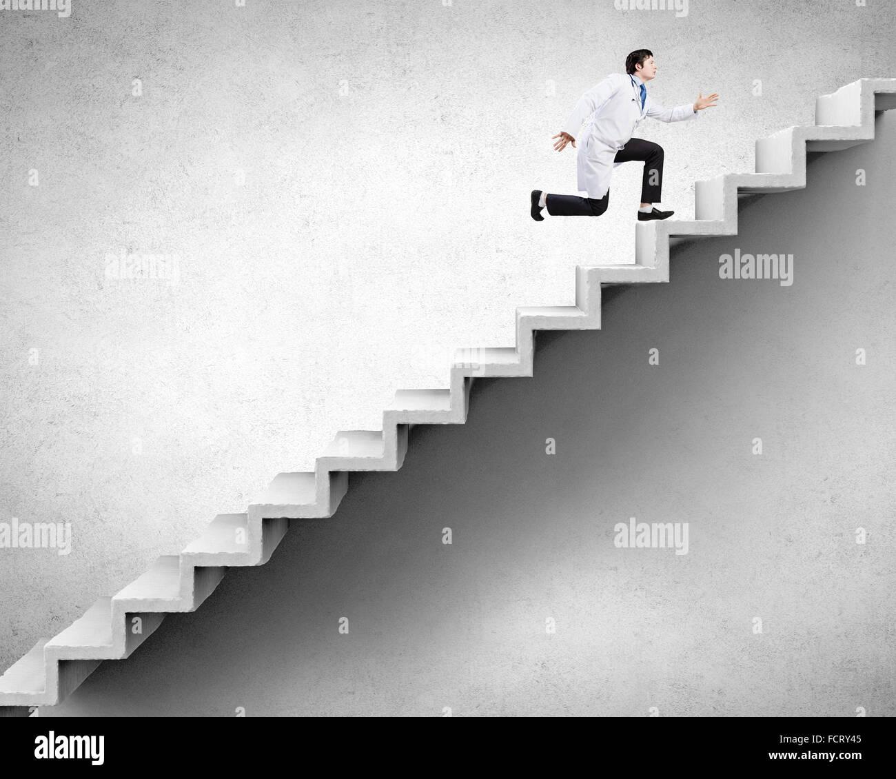 Young businessman walking up on staircase representing success concept ...
