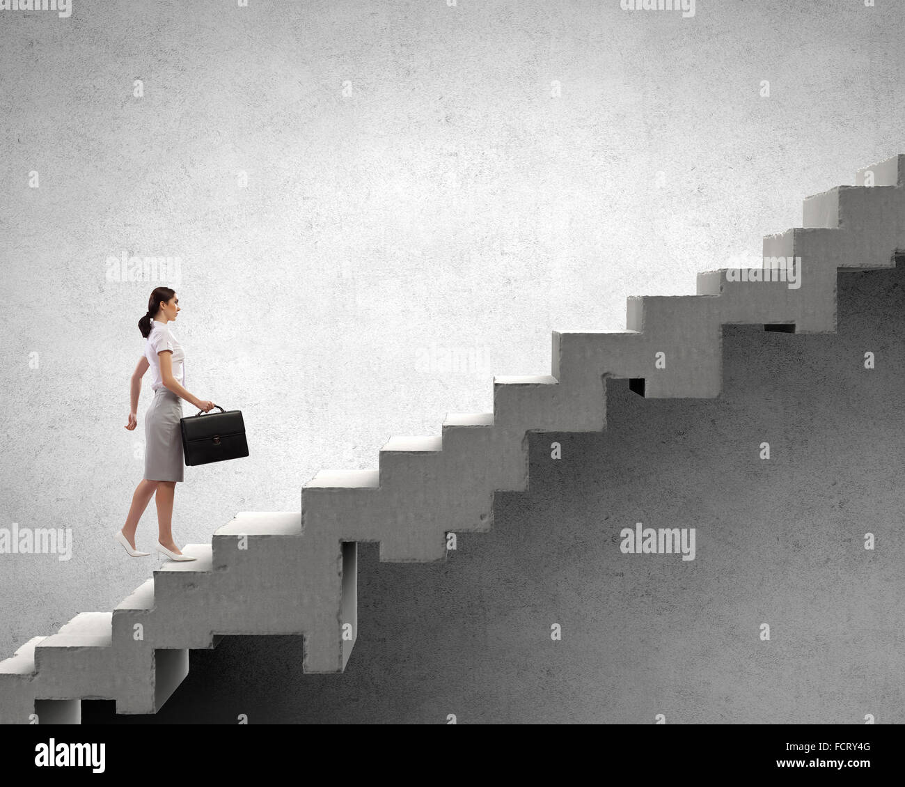 Young businesswoman walking up on staircase representing success ...