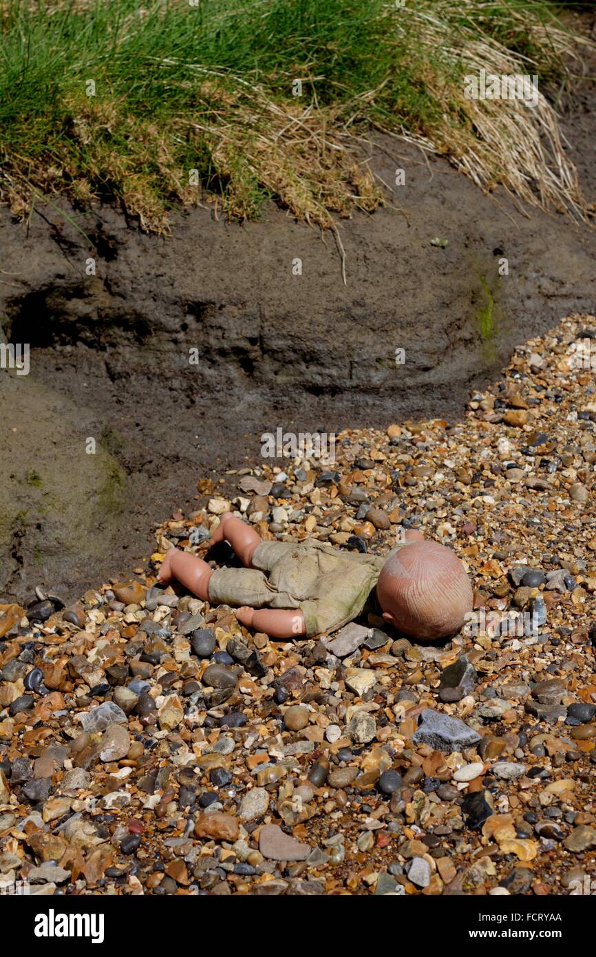 Abandoned Faded Baby Doll Face Down in Gravel Stock Photo - Alamy