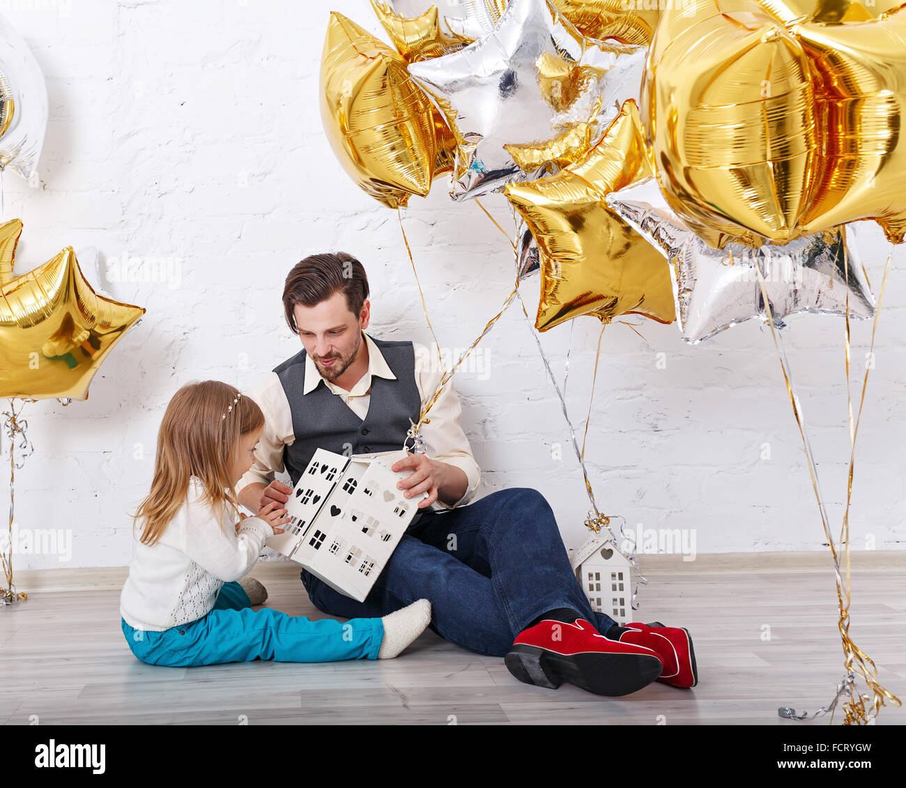 Father plays with daughter. Helium balloons. Family celebration. Family ...